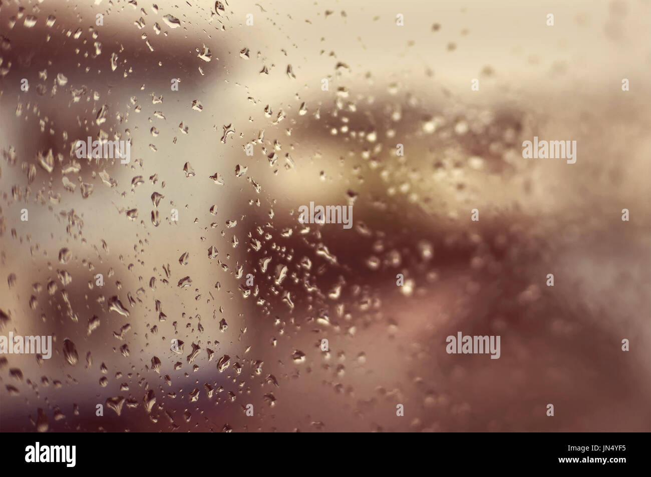 Rain drops on glass window. A sad sad concept, bad weather outside the ...