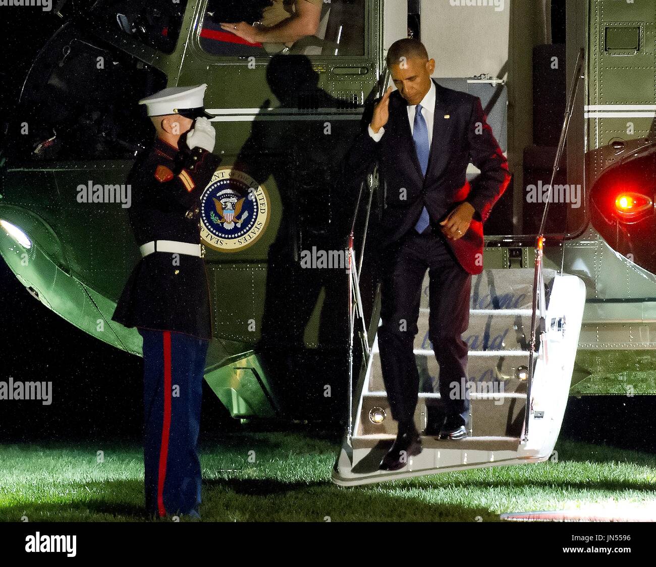 United States President Barack Obama salutes the Marine Guard as he ...