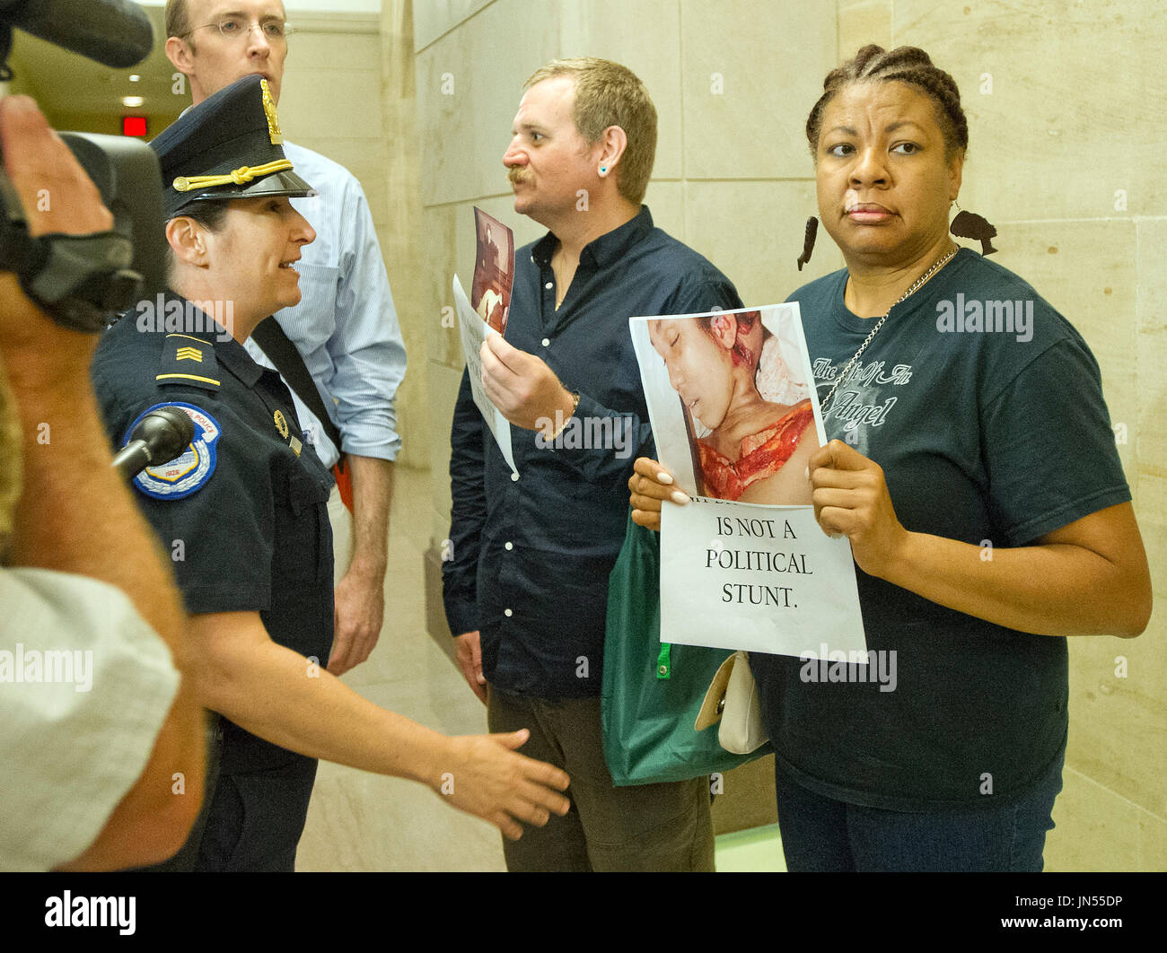 Friends and family who have lost loved ones to gun violence stage a sit ...