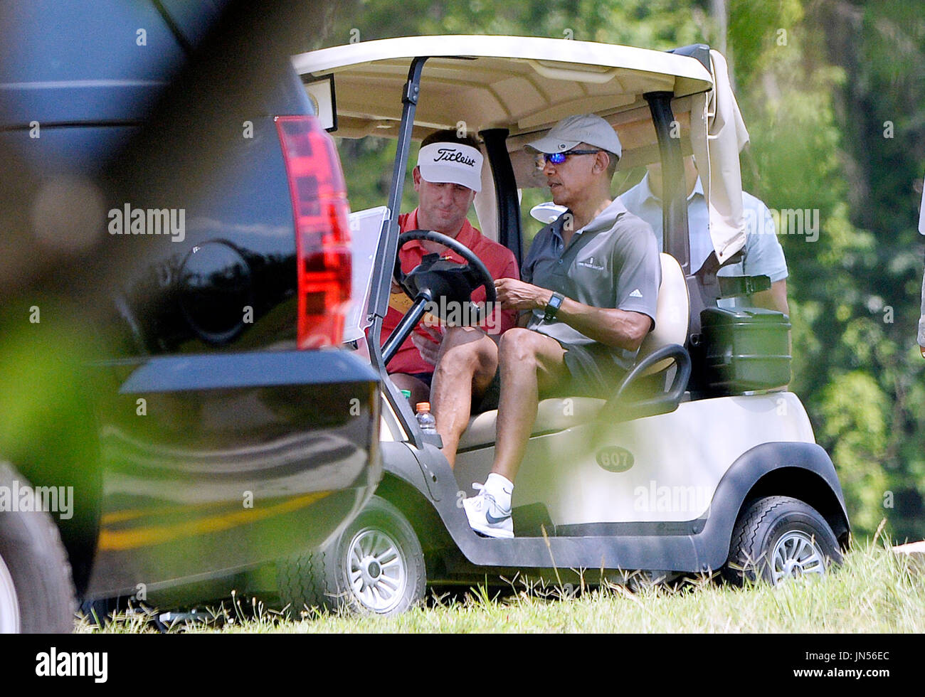 United States President Barack Obama parks his golf cart after playing ...