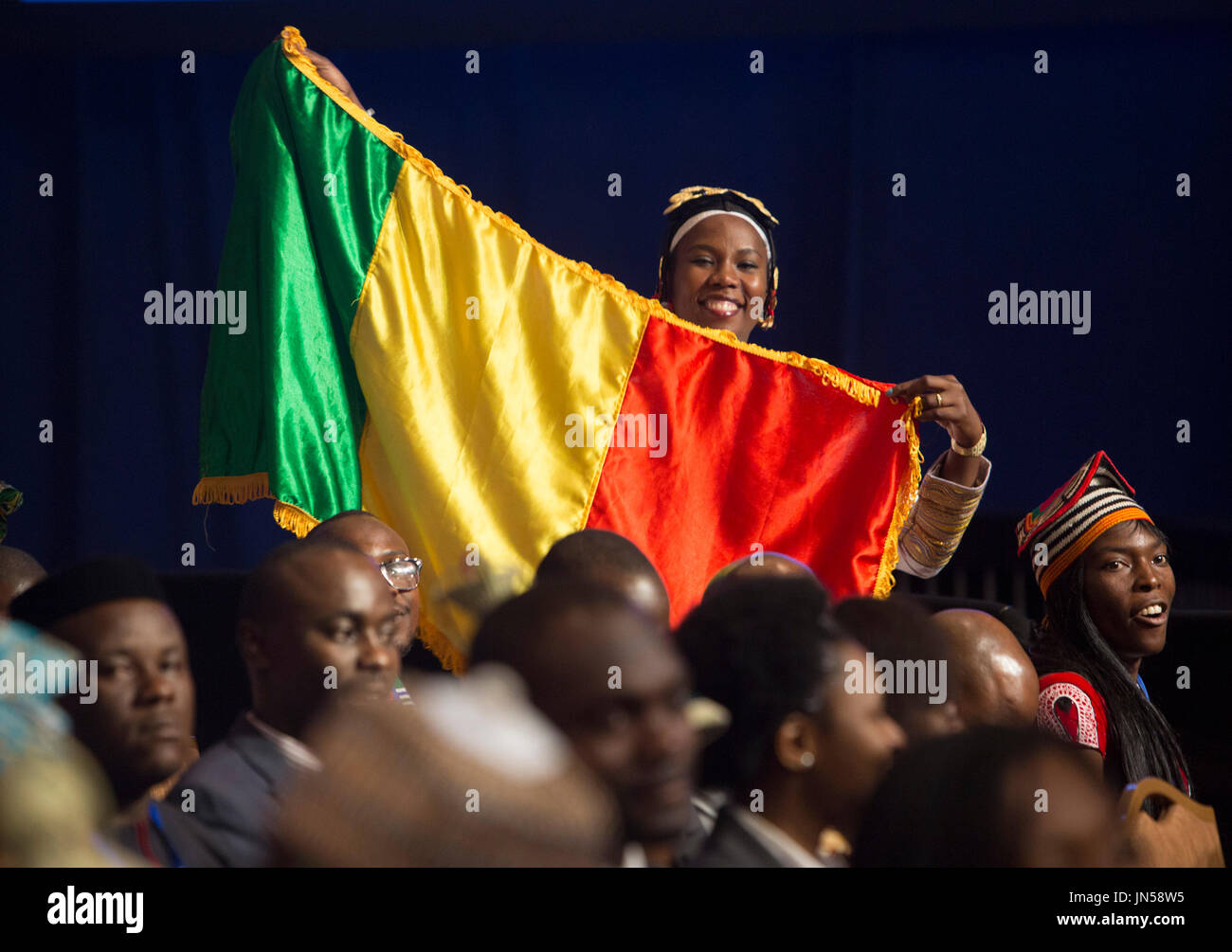 An attendee shows a flag in anticipation of the arrival of United ...