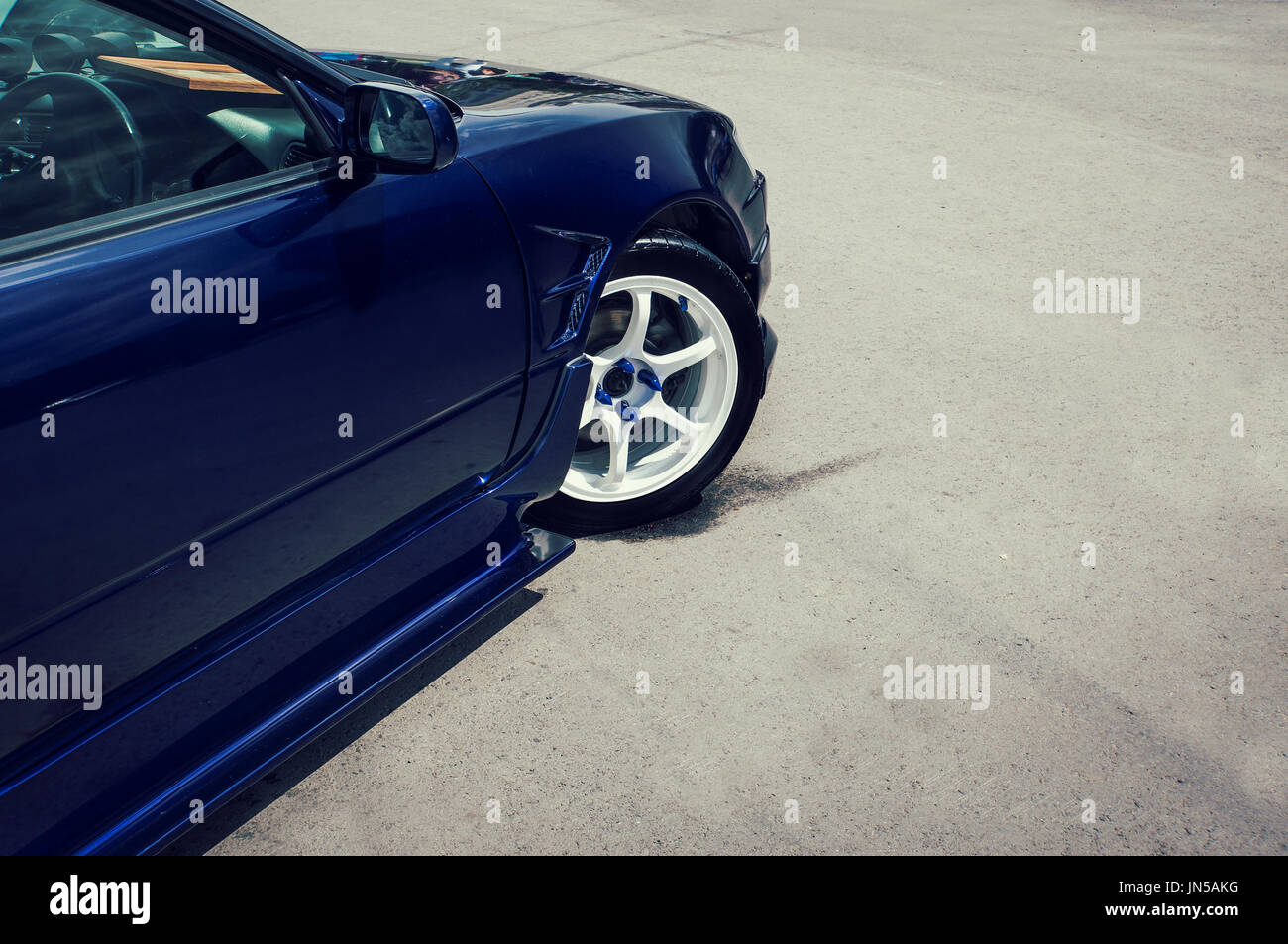 Alloy wheel of luxury car in view side. Side view of turning luxury car ...