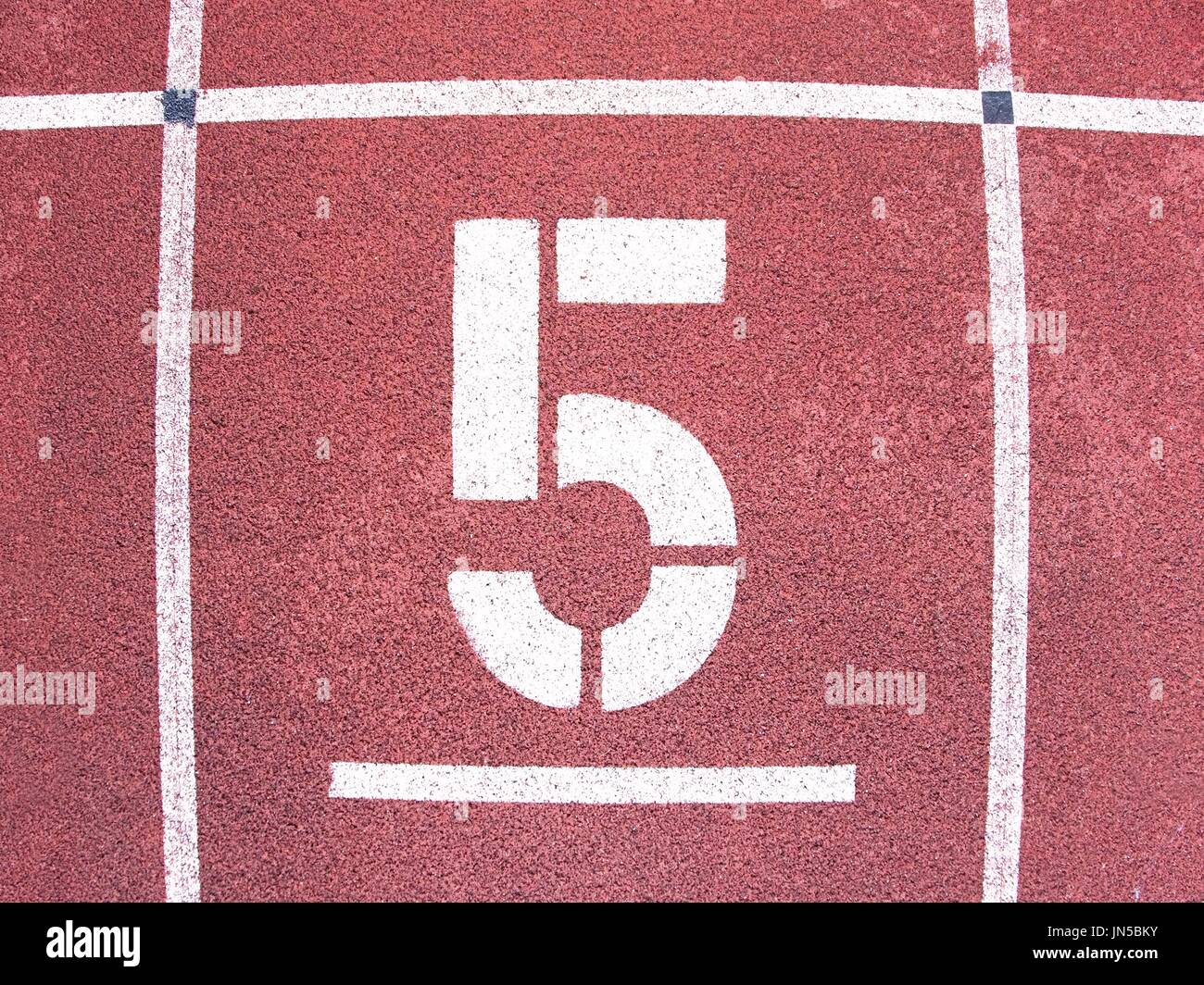 Number five. Big white track number on red rubber racetrack. Gentle ...