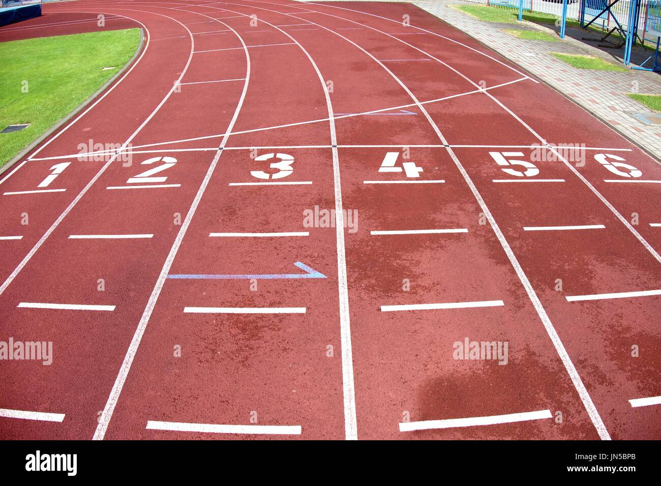 Red running racetrack on the stadium Stock Photo - Alamy