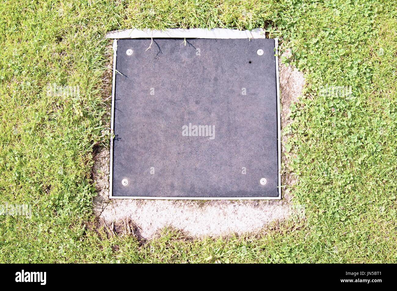 Metal manhole square cover drainage system in the midst of cropped ...