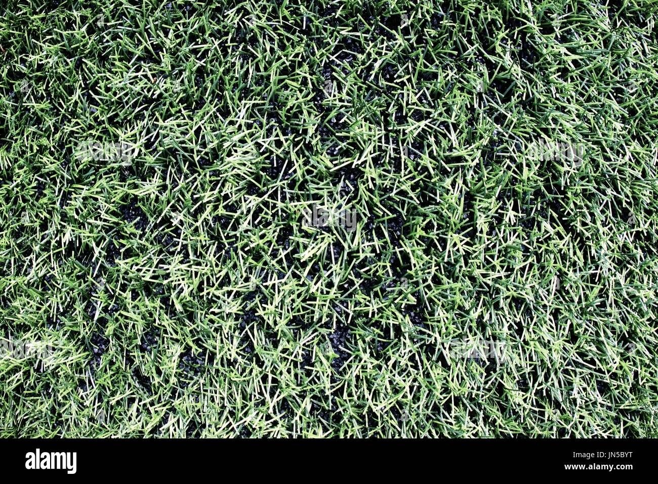 View into plastic grass, artificial green turf texture background Stock ...