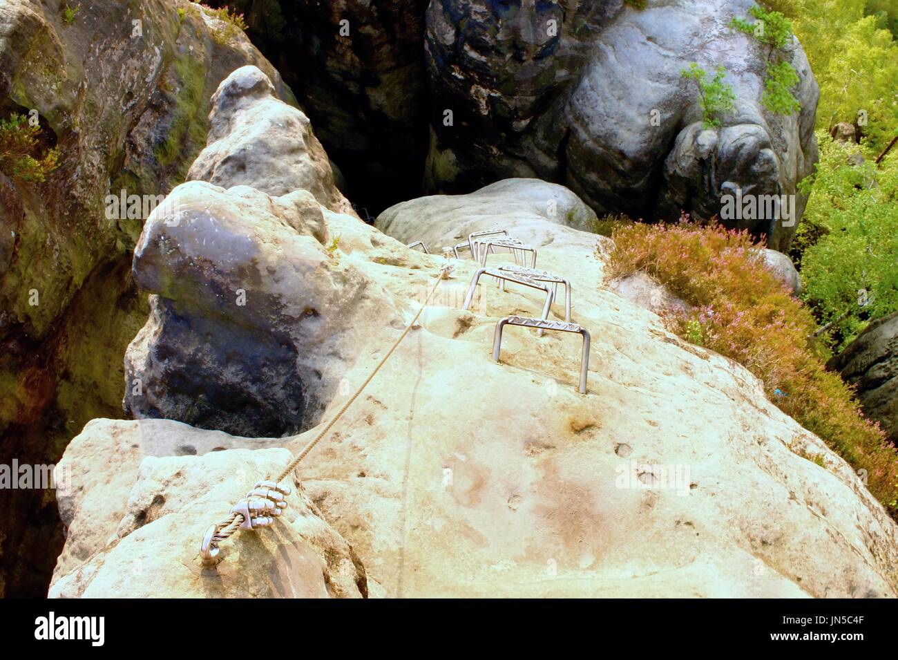 Climbers ladder. Iron twisted rope fixed in block by screws snap hooks ...