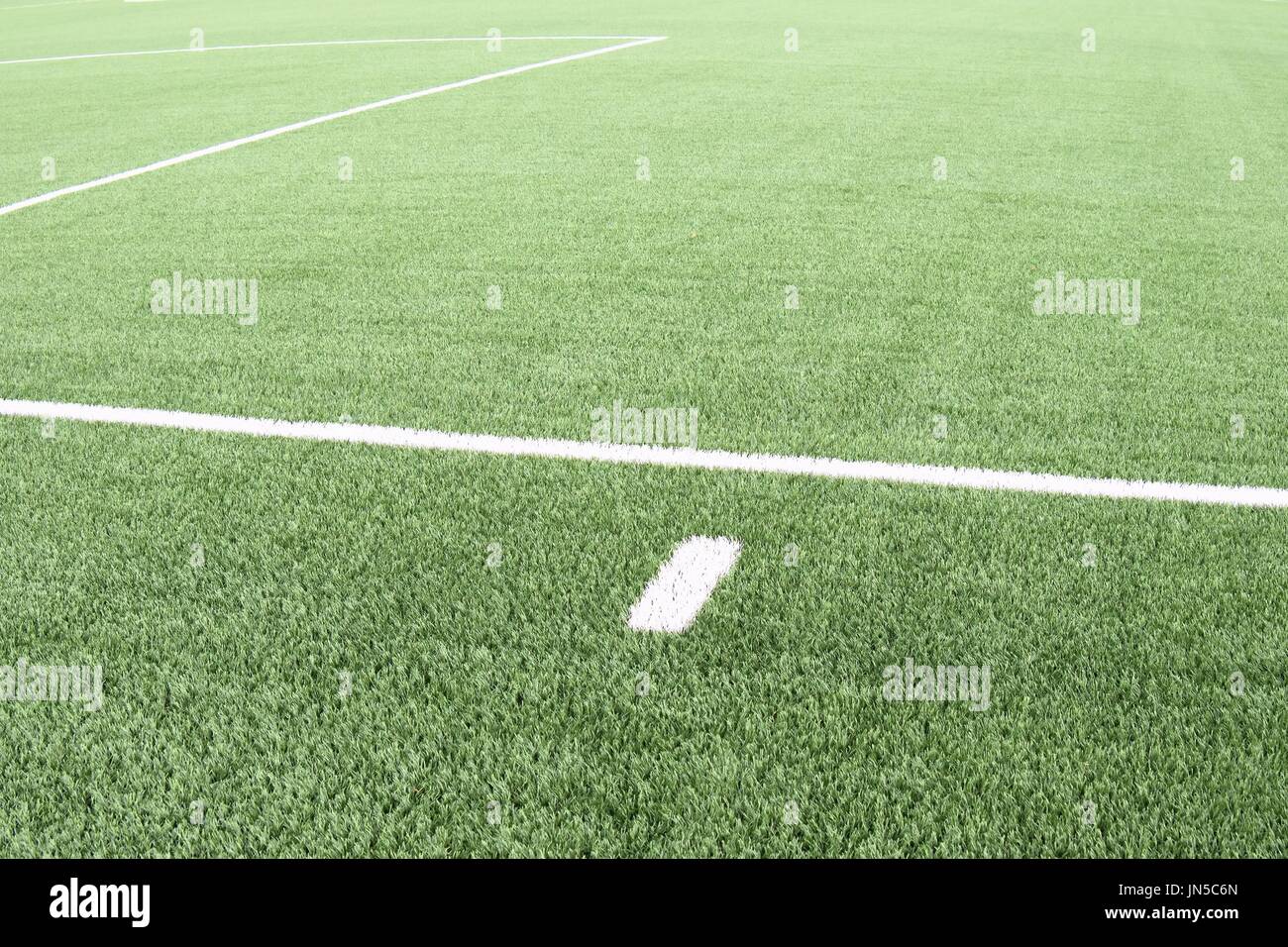 White lines on football playground. Detail of lines in a field. Plastic ...