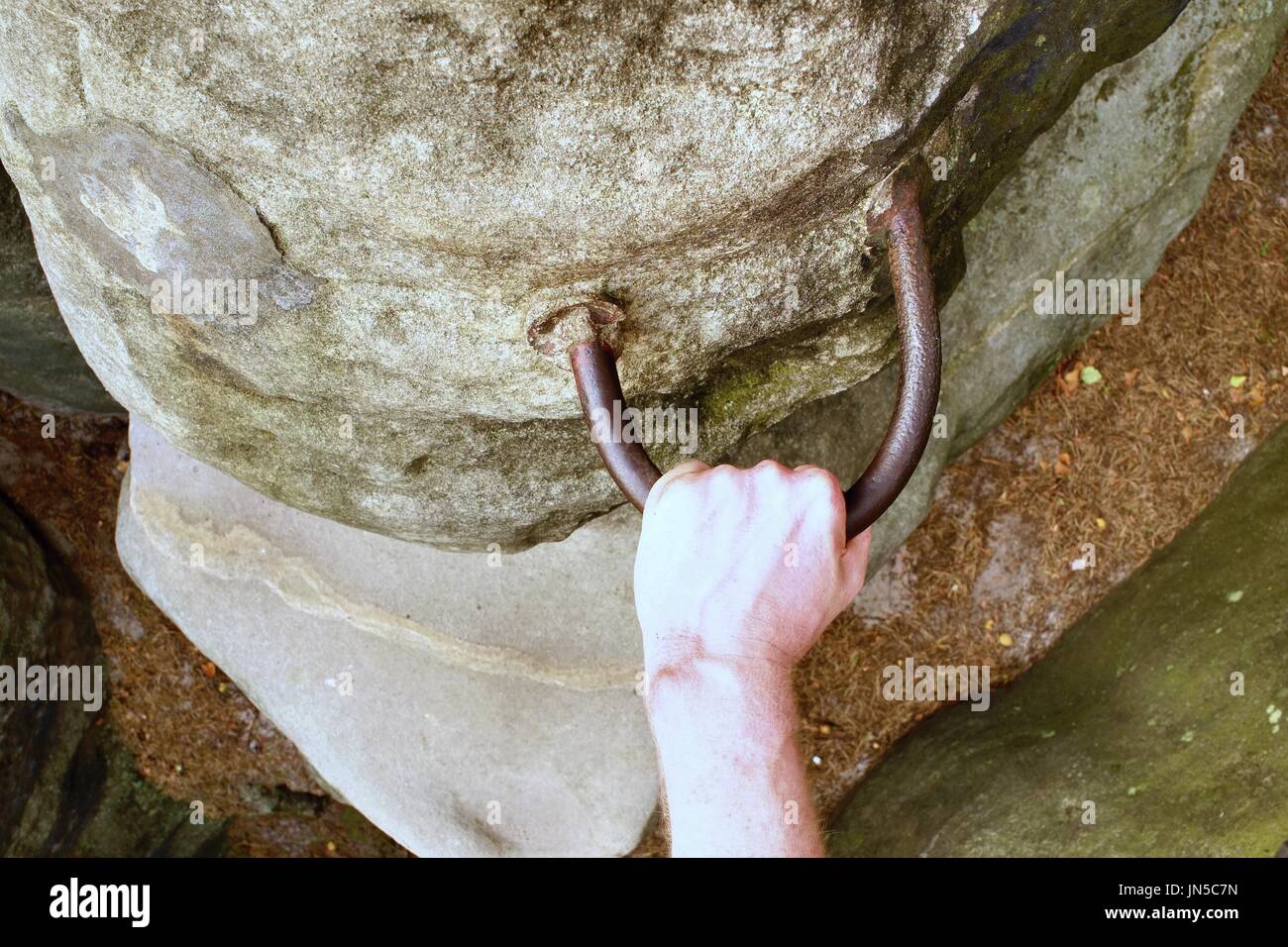 Rock climber's hands on steel handhold anchored in sandstone rock Stock ...