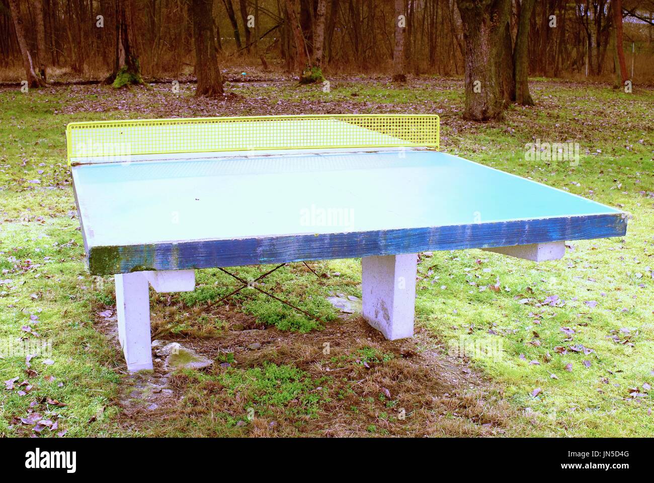 Outdoors green concrete ping pong table, rusty yellow net Stock Photo ...