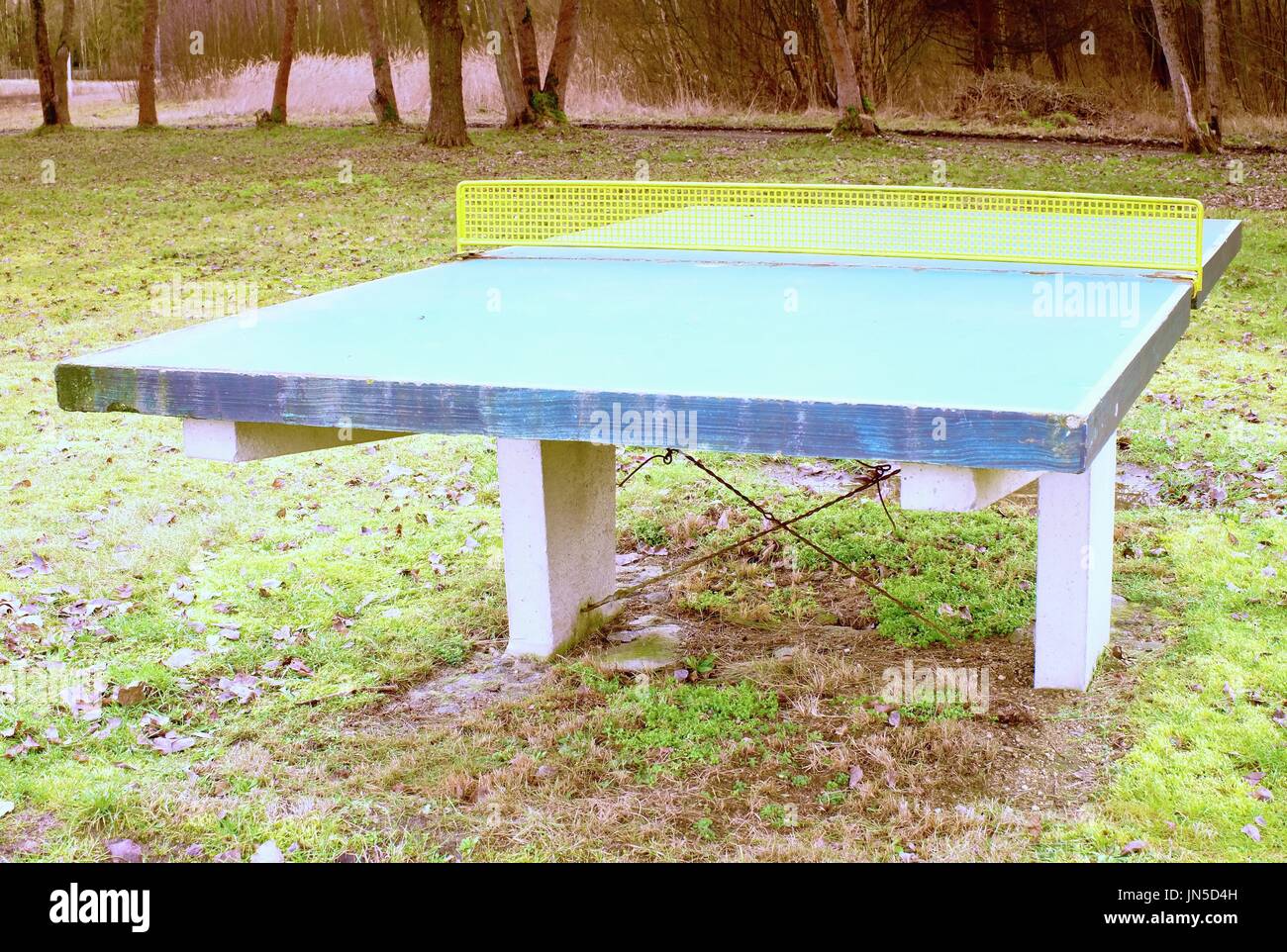 Outdoors green concrete ping pong table, rusty yellow net Stock Photo ...