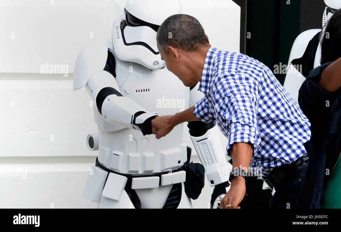 United States President Barack Obama (R) gives a fist bump to a storm ...