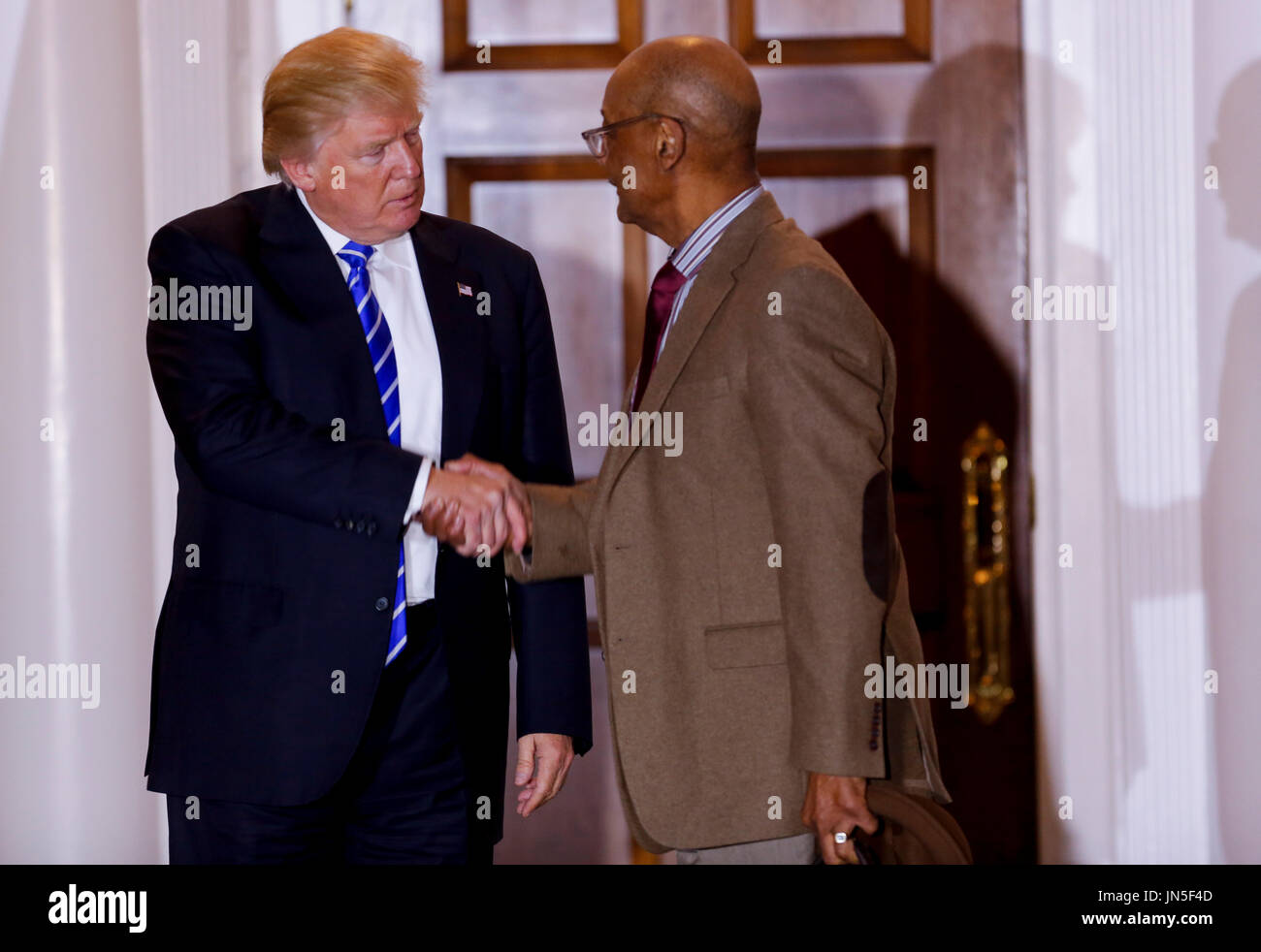 United States President-elect Donald Trump (L) shakes hands with Bob ...