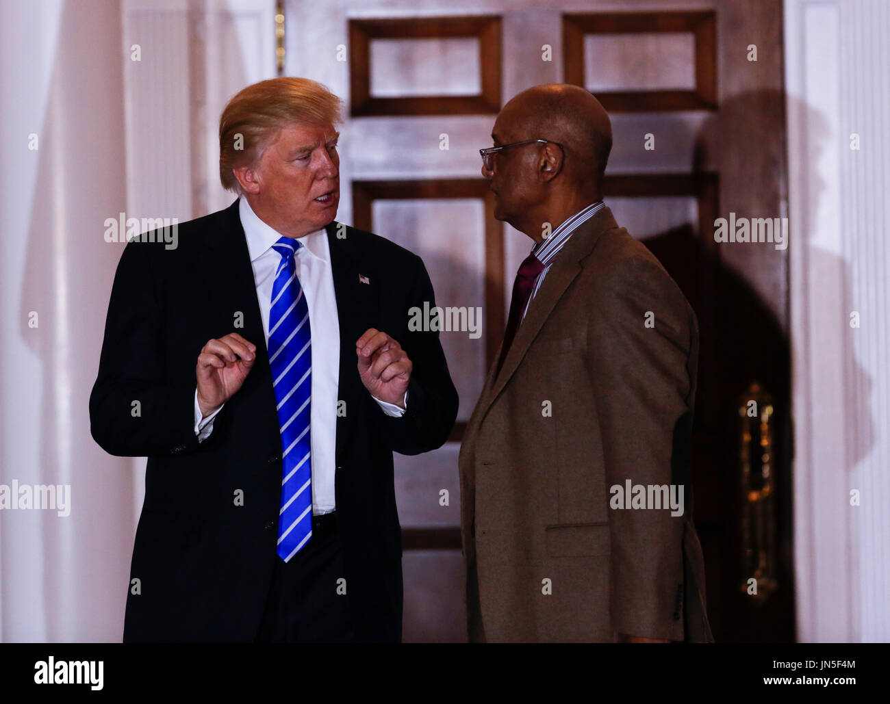 United States President-elect Donald Trump (L) shakes hands with Bob ...