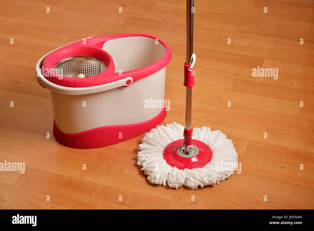 Cleaning mop and Bucket With Drying Spinner on Wooden Floor Stock Photo ...