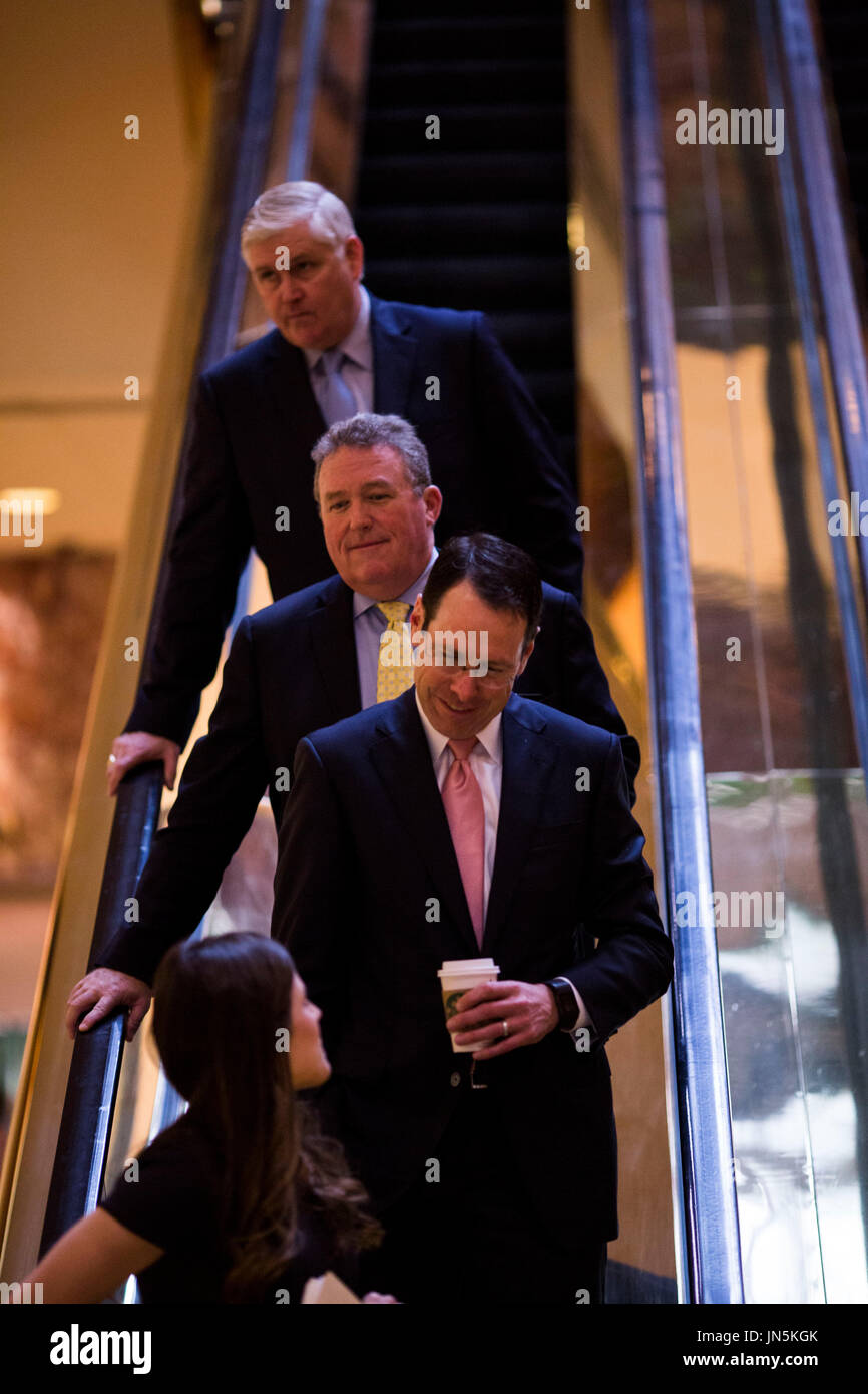 Randall Stephenson, the CEO of AT&T (in front with pink tie) arrives at ...