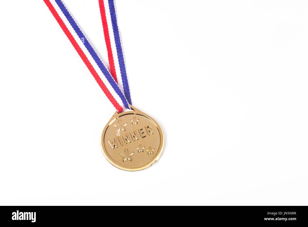 Winners gold medal on a ribbon isolated on white awarded to the first ...