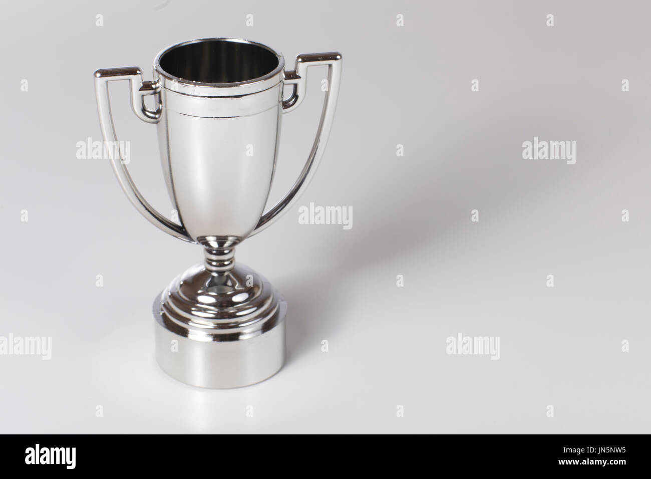 Silver trophy for the winner of a competition over a light grey ...