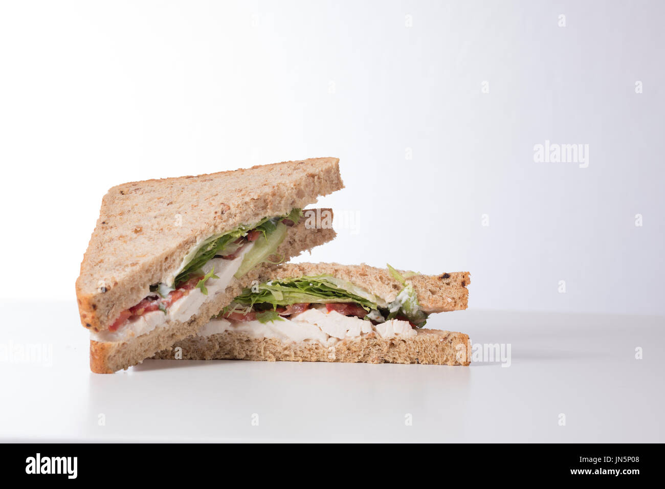 A fresh, healthy wholegrain bread chicken salad sandwich sliced into ...