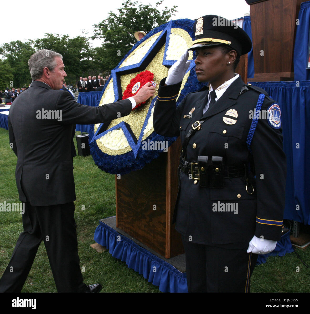 United States President George W. Bush makes places a rose in a wreath ...