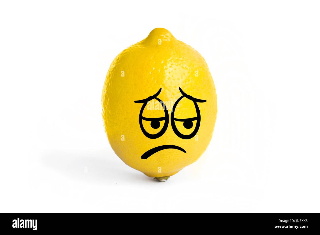Sour sad face on a lemon.. One lemon isolated on white background ...