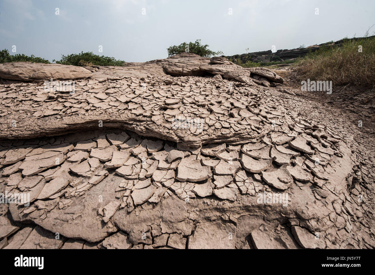 Golden crack earth, dry ground surface, gold brown clay soil texture ...