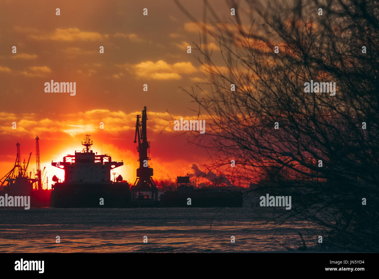 Colorful winter sunrise against the cargo port Stock Photo - Alamy