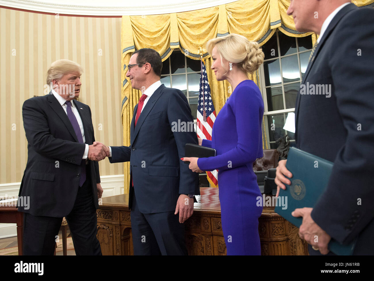 United States President Donald Trump shakes hands with Treasury ...