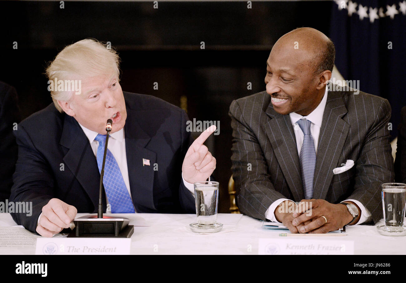 United States President Donald Trump (C) speaks as Kenneth Frazier ...
