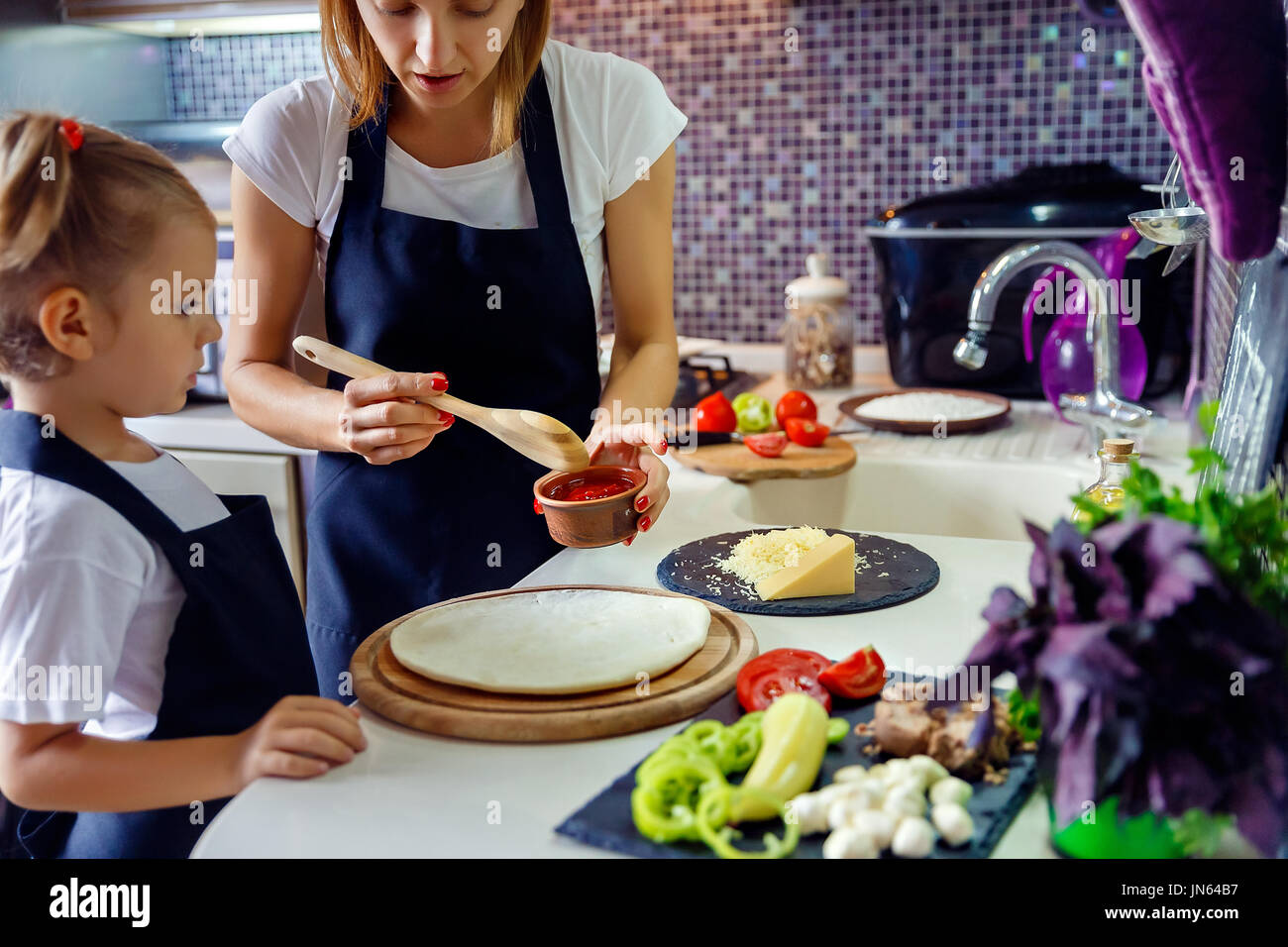 Woman cooking with little girl Stock Photo - Alamy