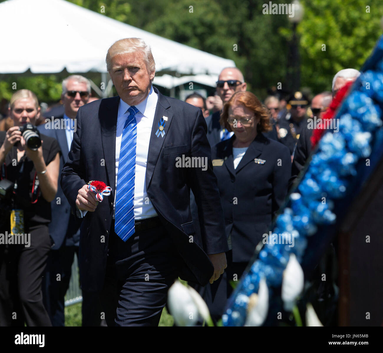 United States President Donald J. Trump places a flower on a memorial ...