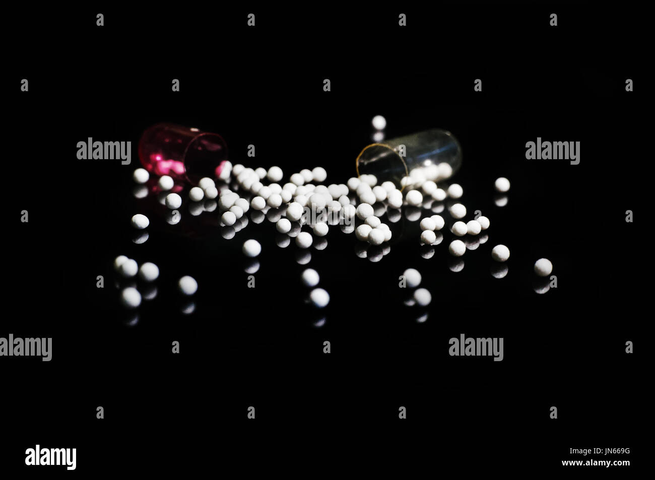 the disclosed pill scattered on the table balls of pill on black ...