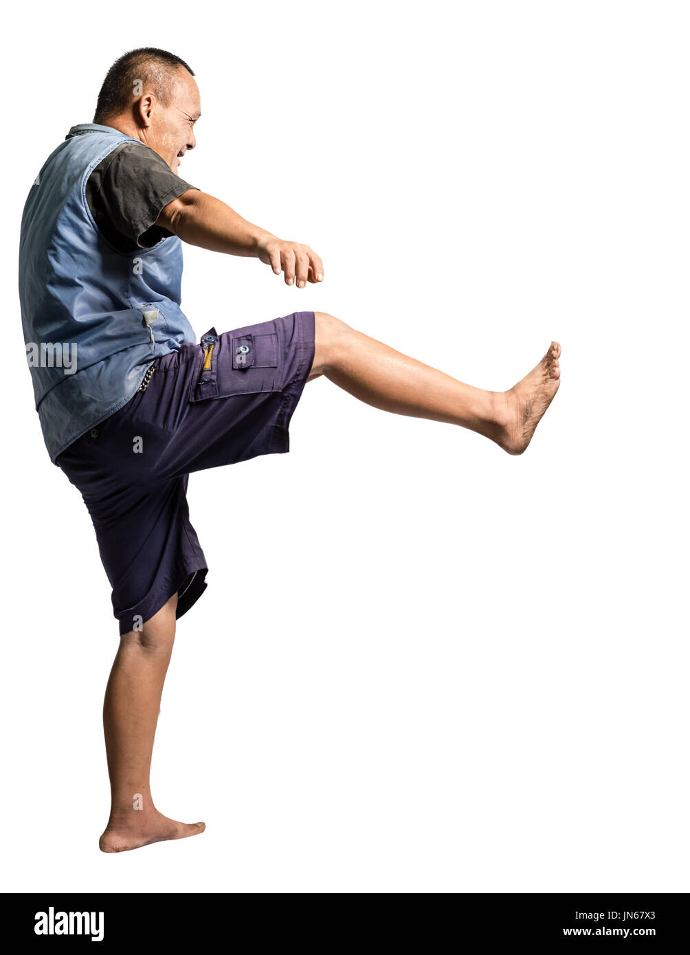 Portrait of a senior asian man in the pose of Kung Fu fighter. Isolated ...