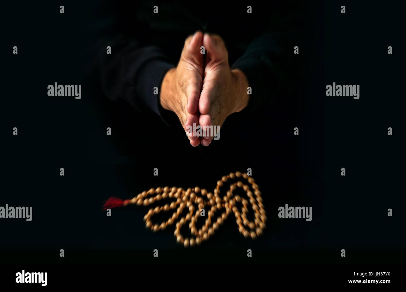 man's hand holding a rosary in a pose of praying and asking Stock Photo ...