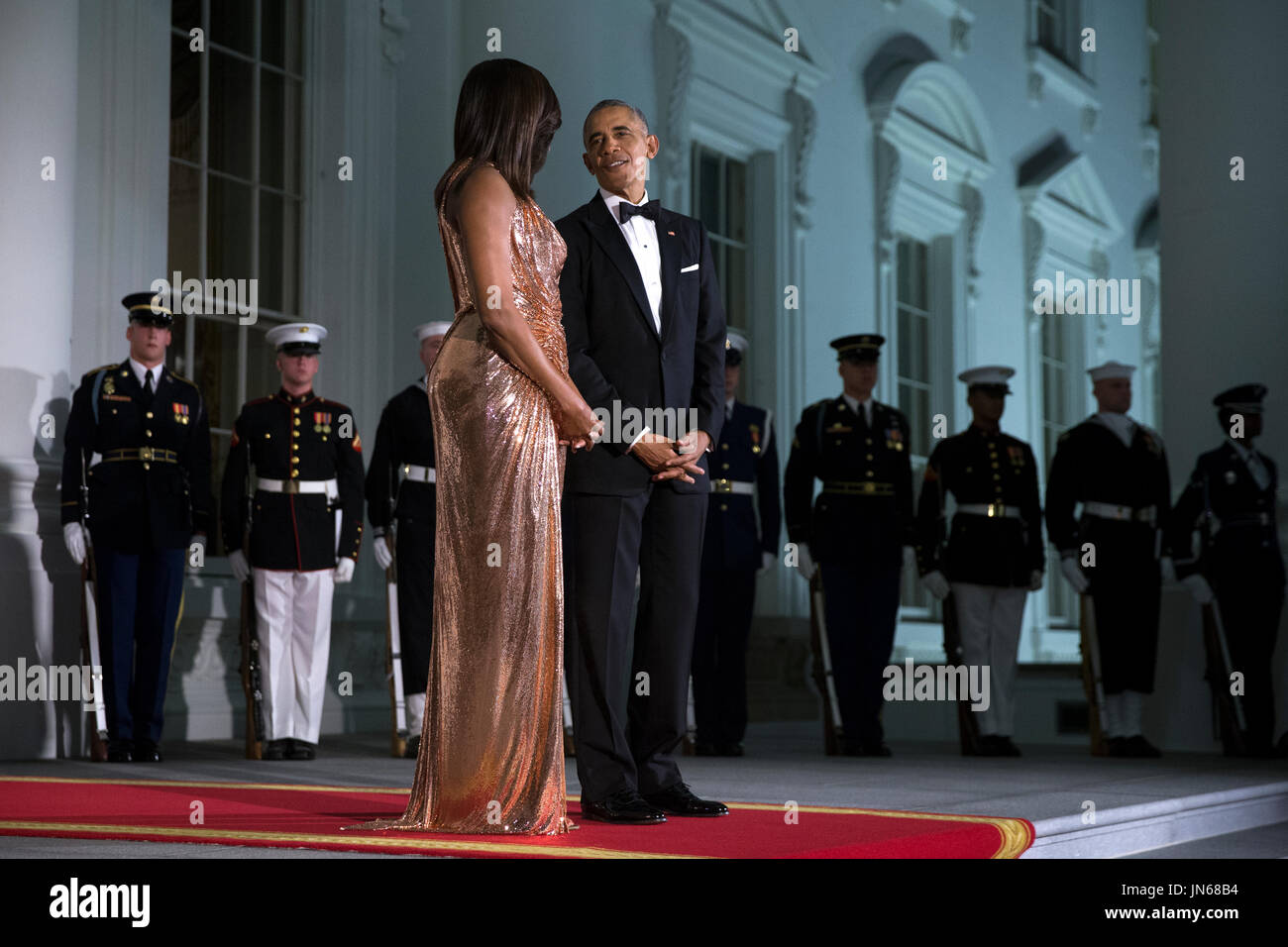 US President Barack Obama (R) and First Lady Michelle Obama (L) wait to ...
