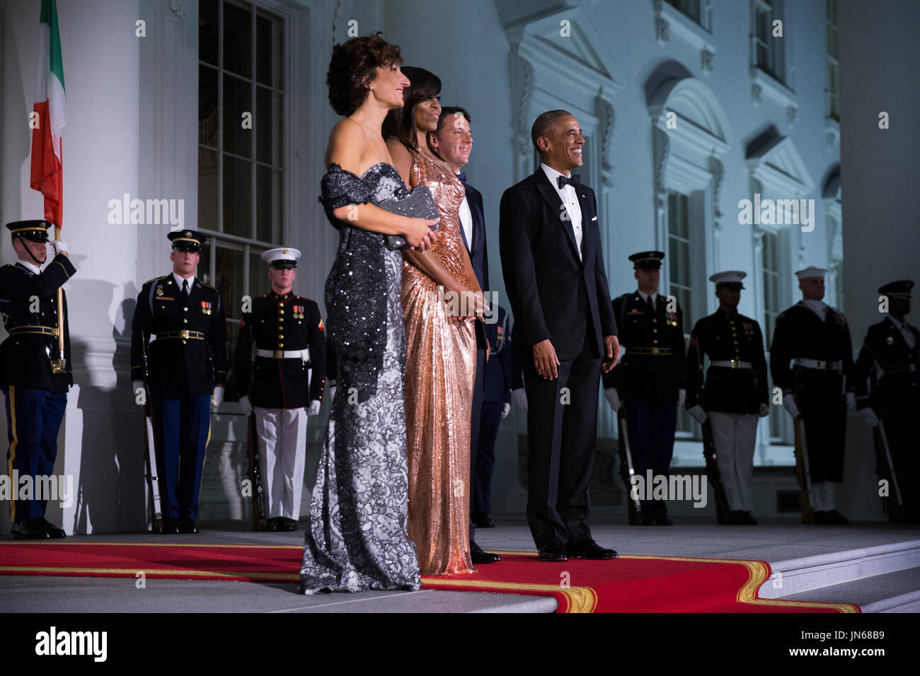 US President Barack Obama (R) and First Lady Michelle Obama (2L) greet ...