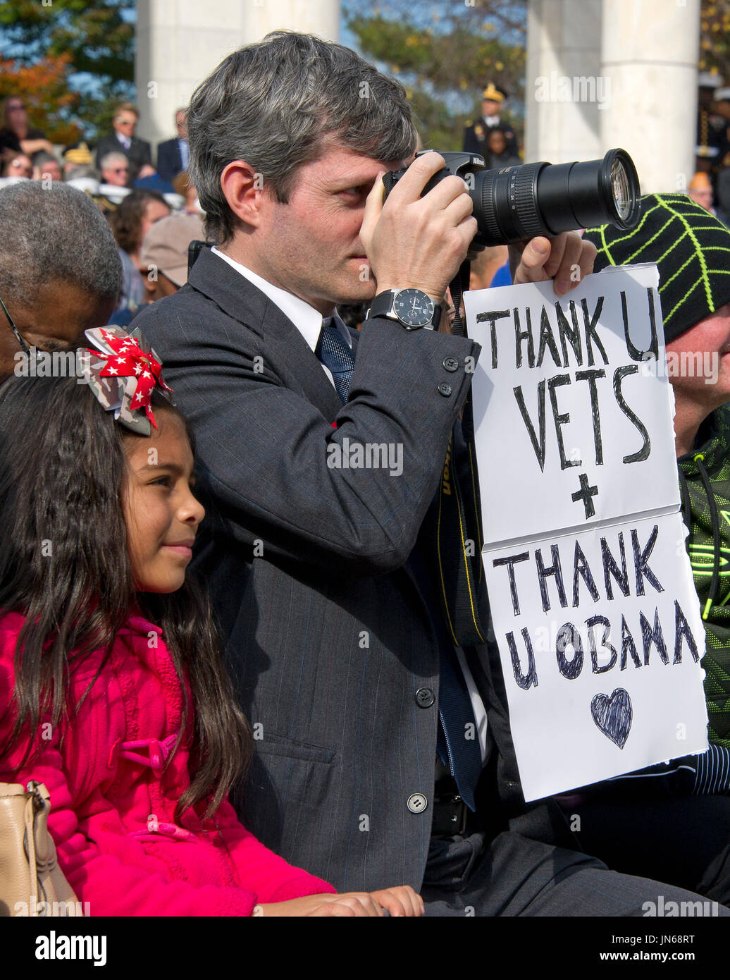 A spectator holds a sign as he takes photos during United States ...