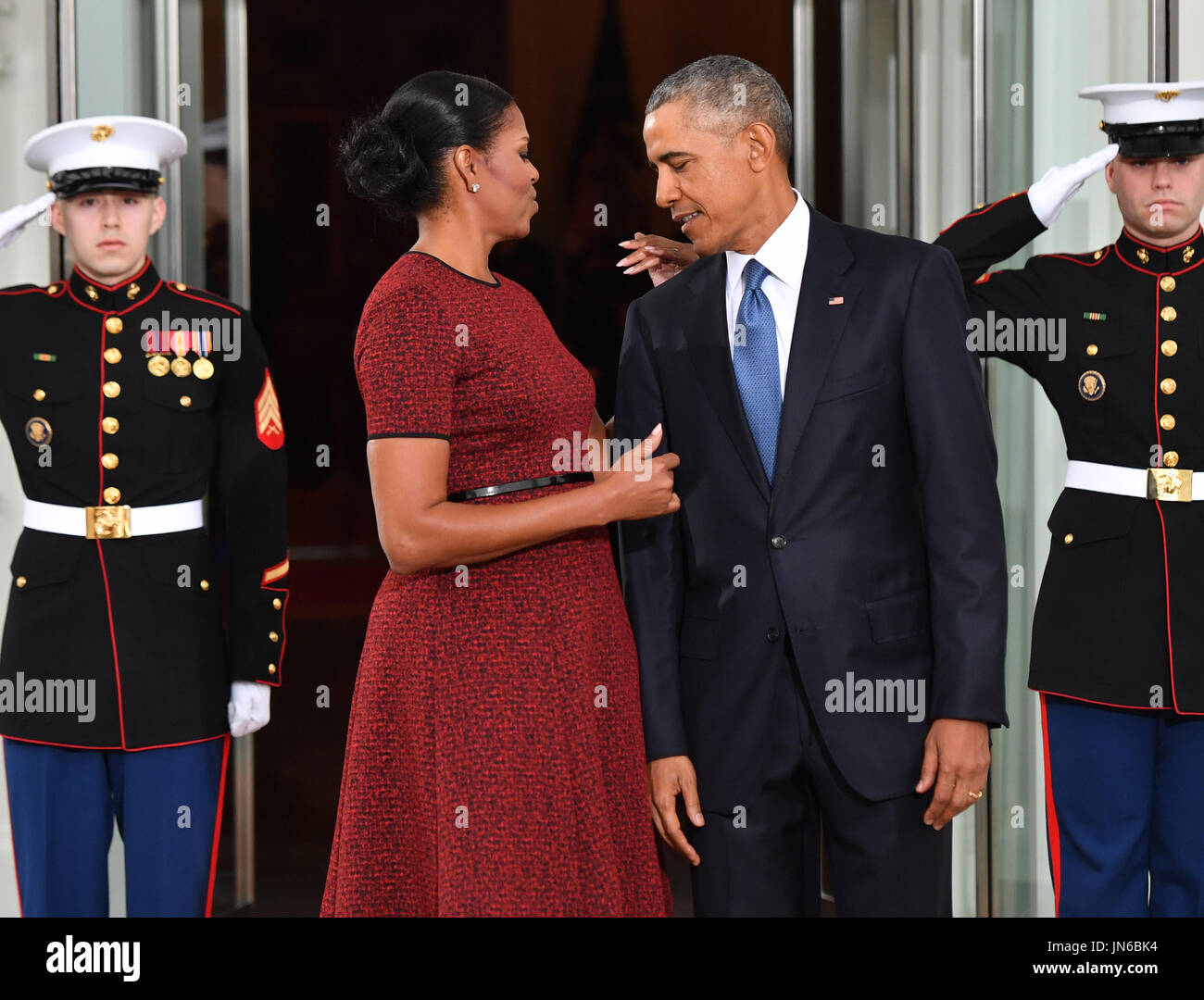 President Barack Obama (R) and Michelle Obama share a moment as they ...