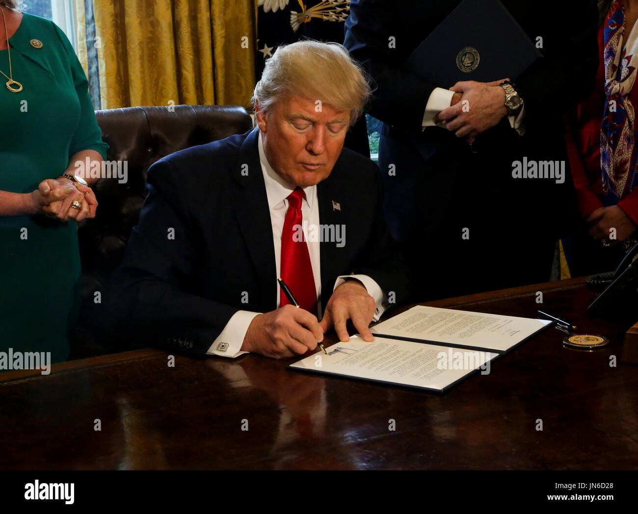 United States President Donald Trump signs an Executive Order in the ...