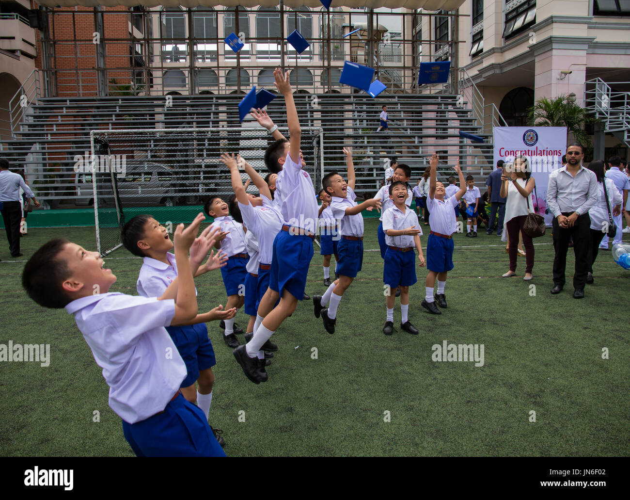 Asian students toss their certificate in the air Stock Photo - Alamy