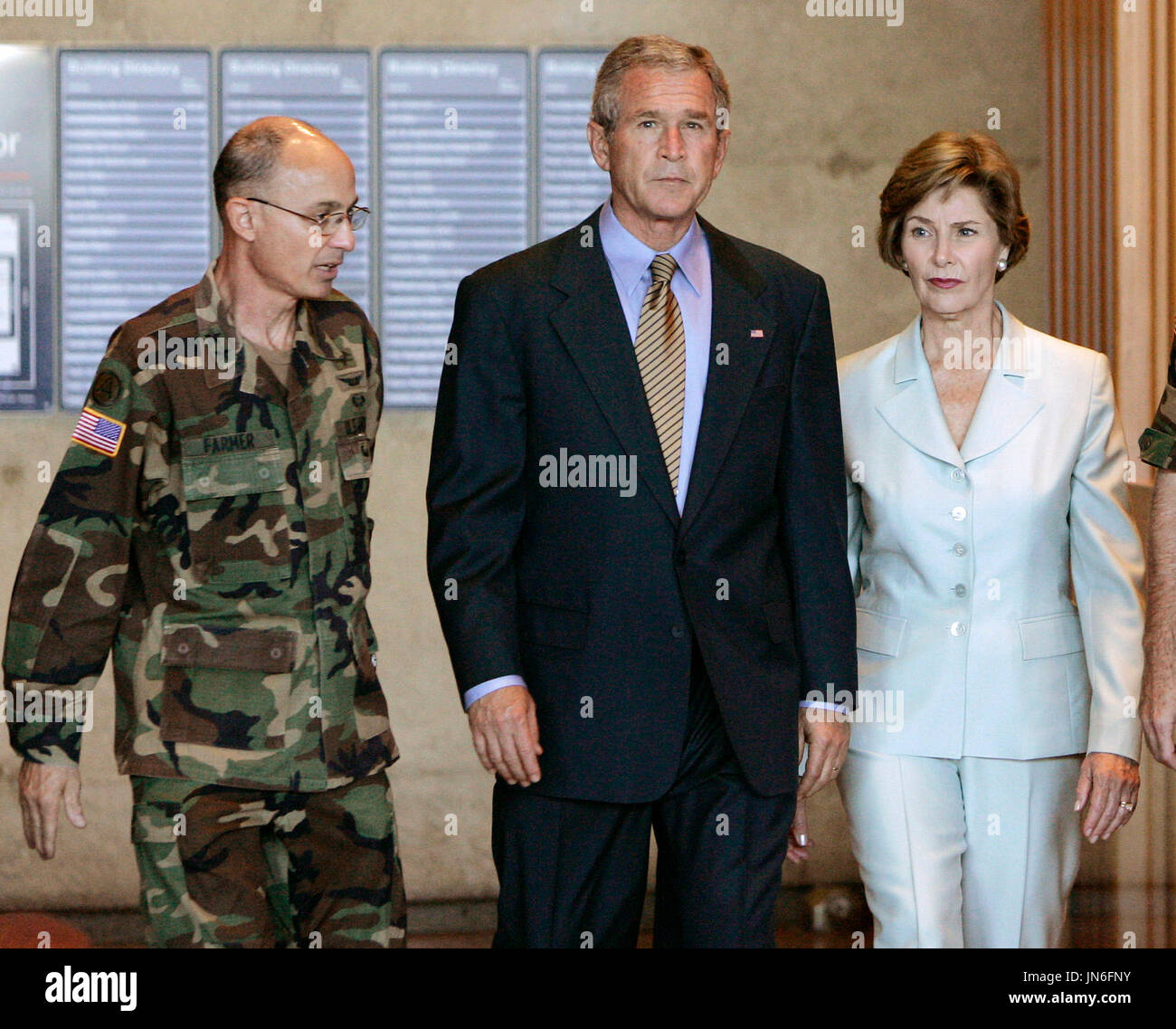 U.S. President George W. Bush (2L) and First Lady Laura Bush walk with ...