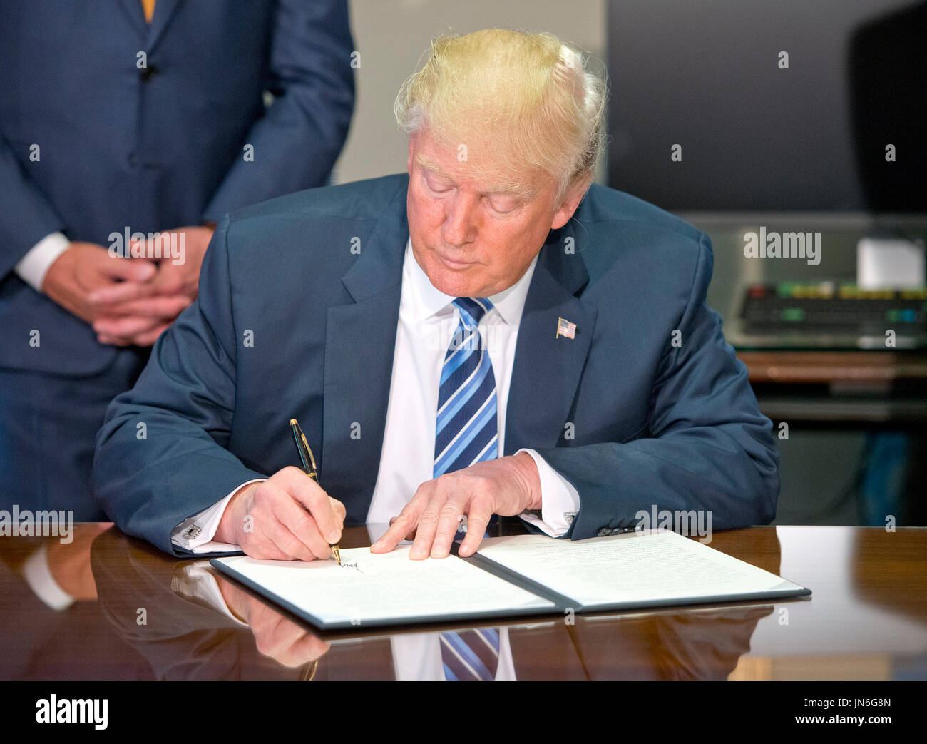 United States President Donald J. Trump signs the first of three ...