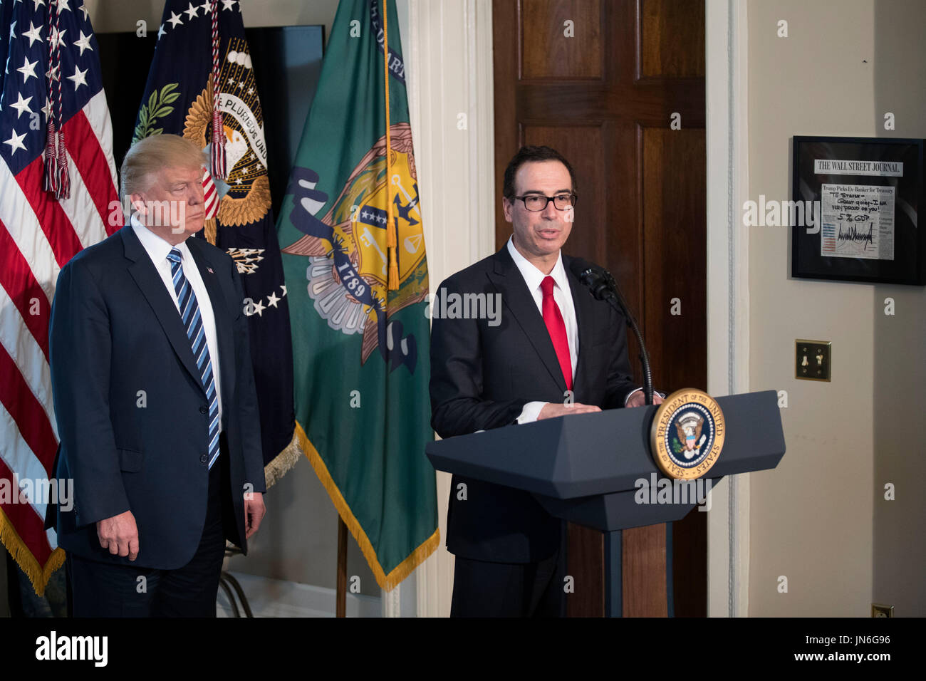 US President Donald J. Trump (L) listens as Secretary of Treasury ...