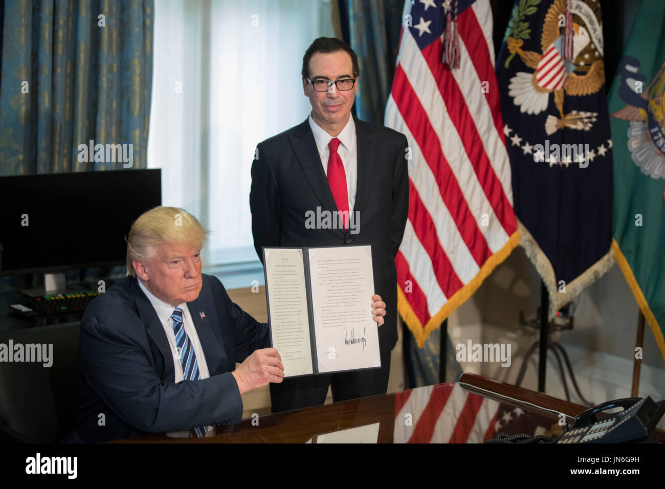 US President Donald J. Trump (L), with Secretary of Treasury Steven ...