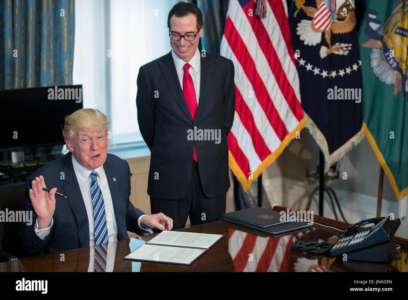US President Donald J. Trump (L), with Secretary of Treasury Steven ...