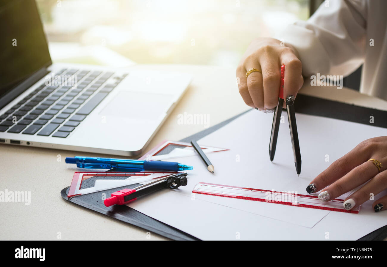 The female architects are using dividers and tools for idesign on the ...