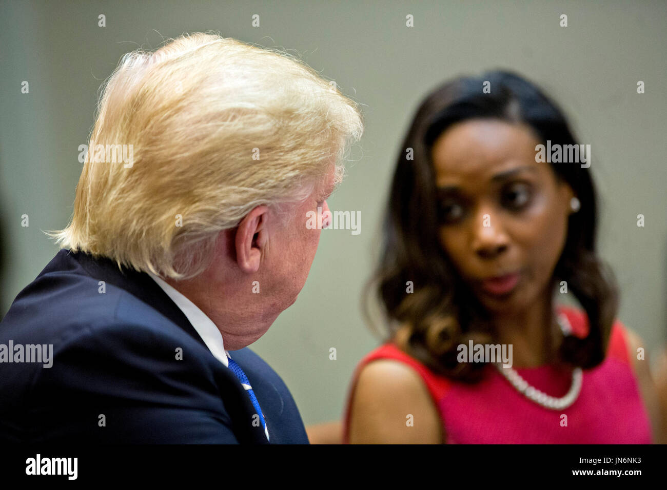 U.S. President Donald Trump listens as Jessica Johnson, president of ...