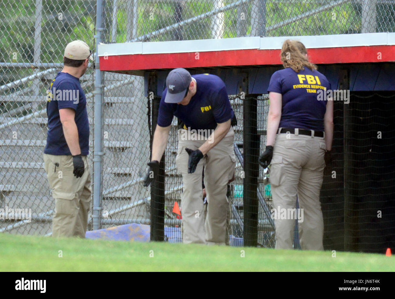 Evidence technicians from the FBI comb through the crime scene for ...