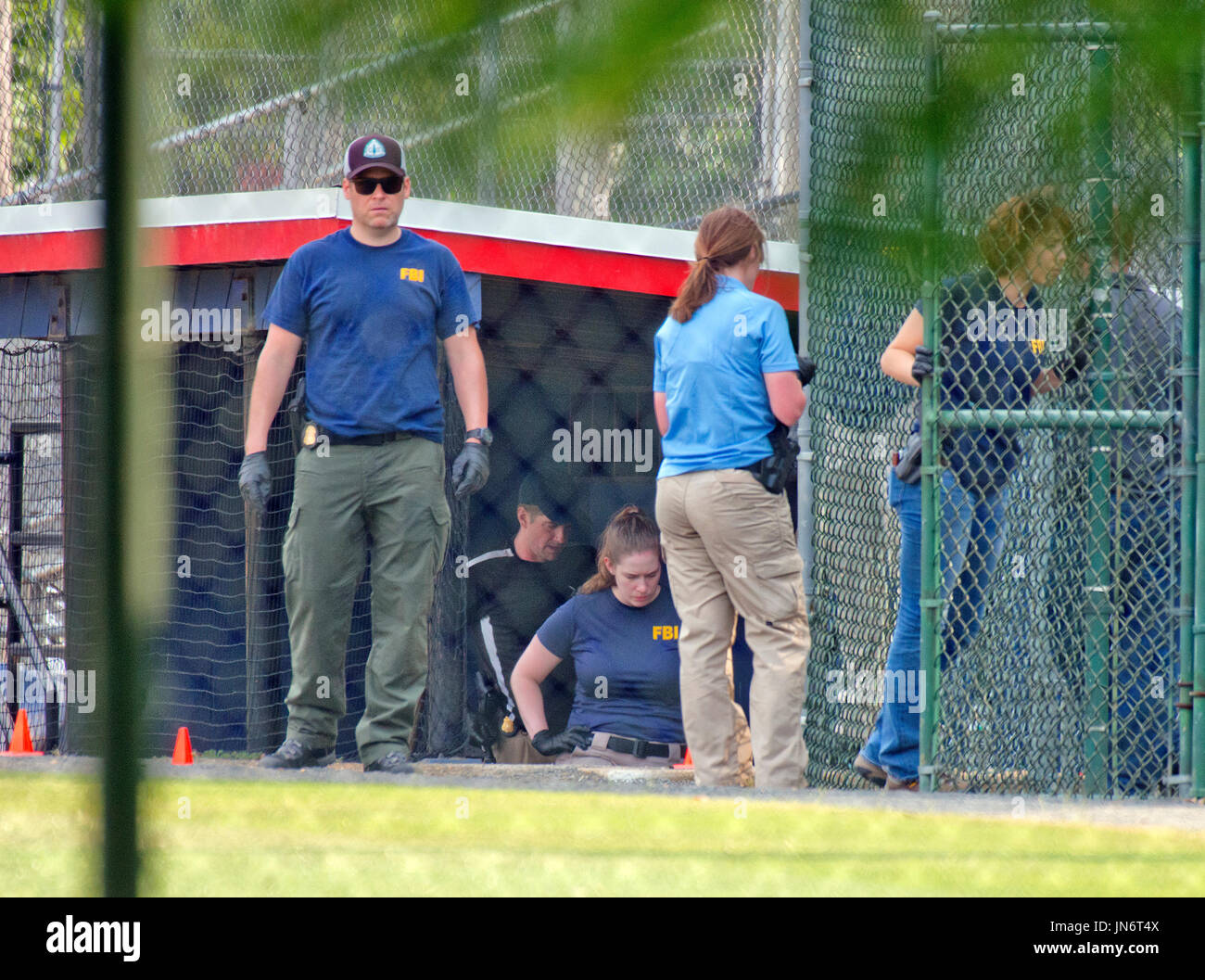 Evidence technicians from the FBI comb through the crime scene for ...