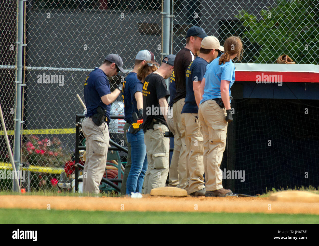 Evidence technicians from the FBI comb through the crime scene for ...